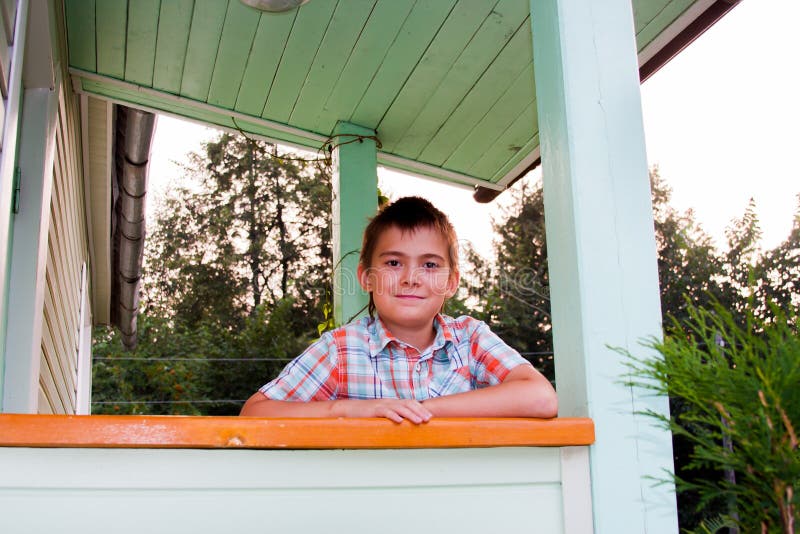 Cheerful Boy Standing on the Porch Stock Photo - Image of fragment ...