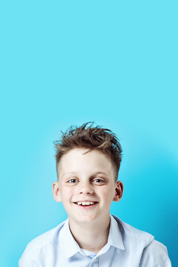 A Cheerful Boy Stands and Smiles in a Light Shirt on a Bright Colored ...