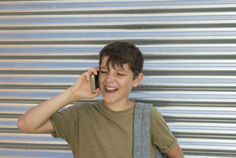 Cheerful Boy Using a Mobile Phone Stock Photo - Image of outdoors, city ...