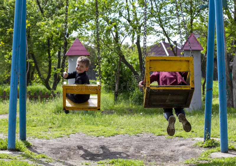Cheerful Boys Ride on Swing Stock Photo - Image of happiness, child ...