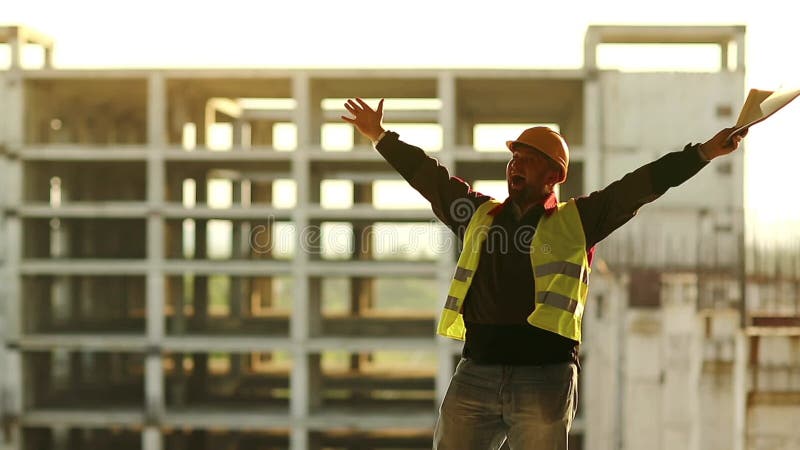 Cheerful Builder with Work Papers on Project Site Stock Video - Video ...