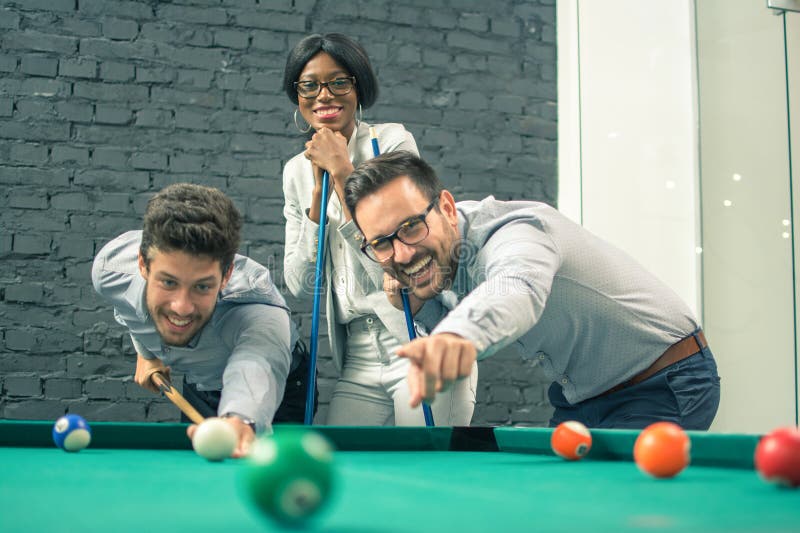 Cheerful Business People Playing Billiards during Office Break Stock ...