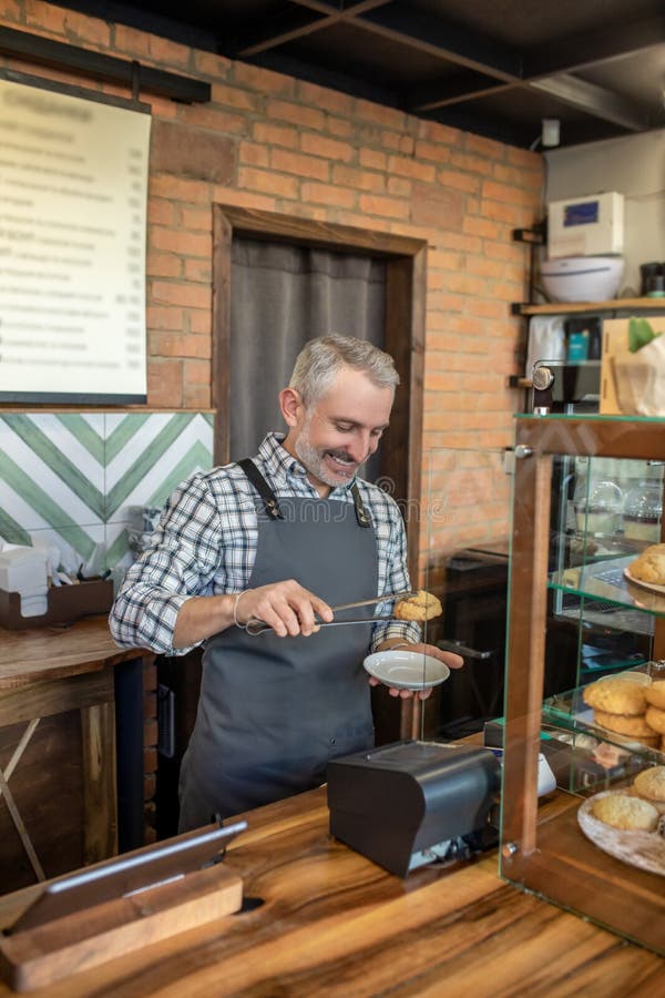 Cheerful Cafe Worker Brewing a Caffeinated Drink for a Client Stock ...