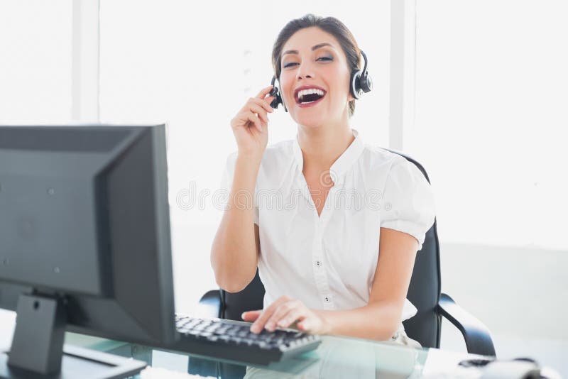 Cheerful Call Centre Agent Sitting at Her Desk on a Call Stock Photo ...