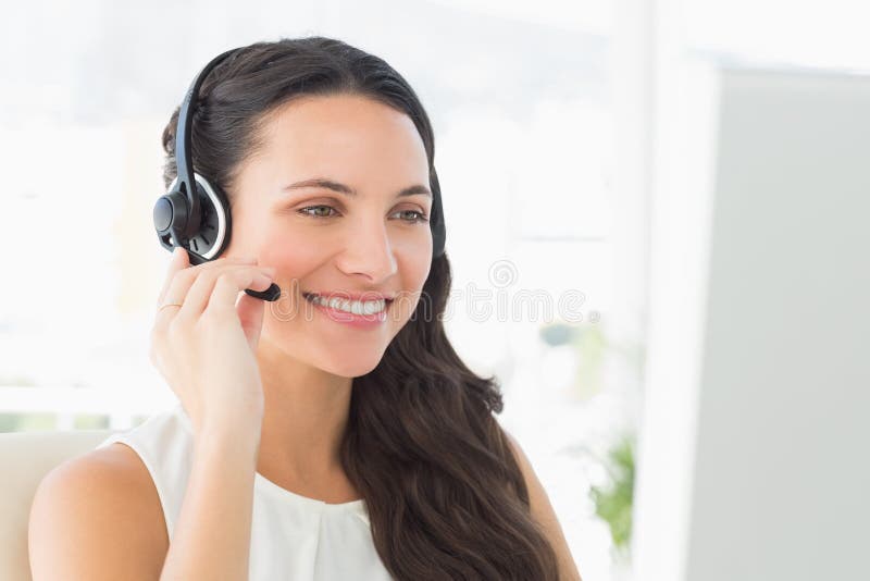 Cheerful Call Centre Agent Sitting at Her Desk Stock Photo - Image of ...