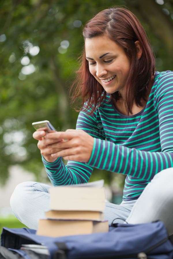 Cheerful Casual Student Sitting on Bench Texting Stock Image - Image of ...