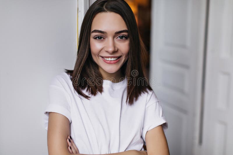 Cheerful Caucasian Woman In White T Shirt Smiling While Chilling In Her