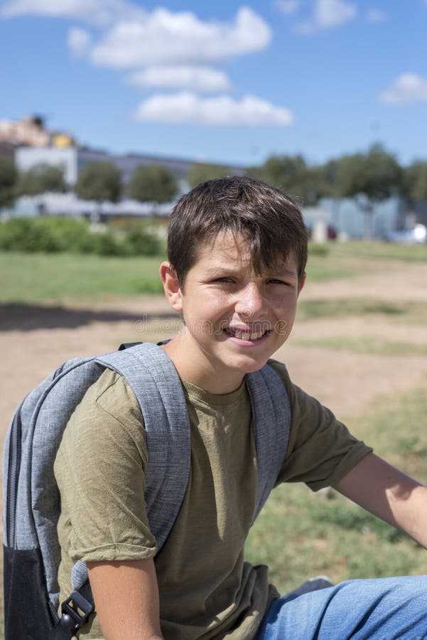 Cheerful Child Carrying His Backpack Standing in Front of the Sc Stock ...