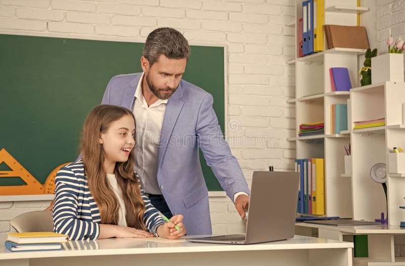 Cheerful Child with Teacher in Classroom Use Laptop Stock Image - Image ...