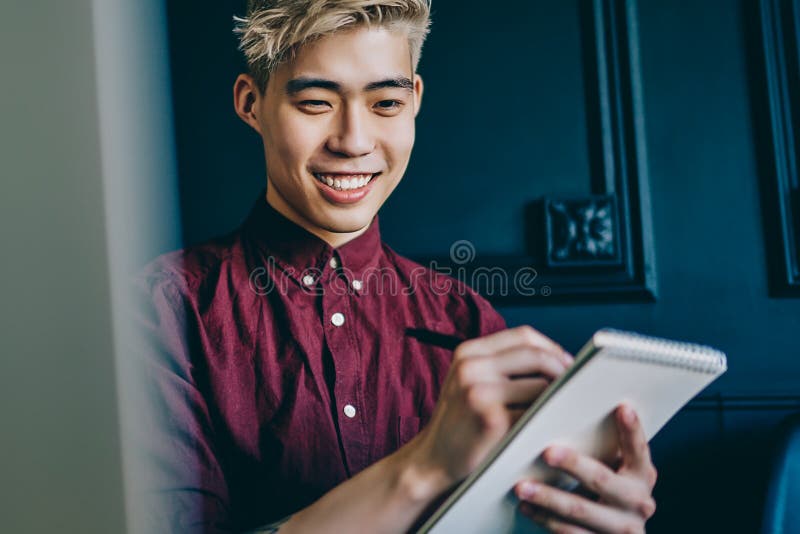 Positive Japanese Hipster Student Drawing Sketch on Notepad Sitting in ...