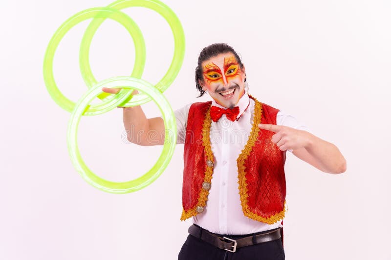 Cheerful Circus Performer Skillfully Juggling a Number of Rings ...