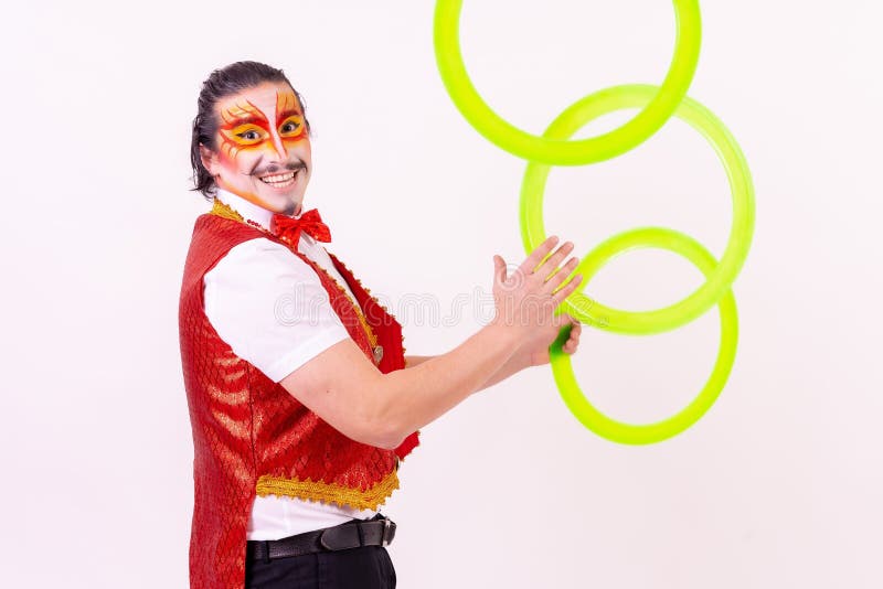 Cheerful Circus Performer Skillfully Juggling a Number of Rings ...