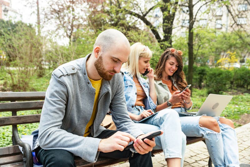 Cheerful Classmates University Students Sitting on a Bench in Spring ...