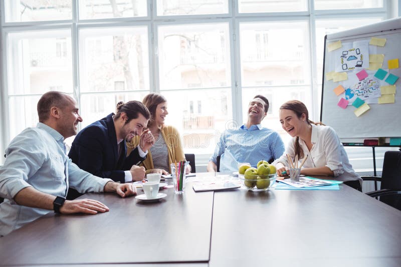 Cheerful Colleagues Discussing in Meeting Room Stock Image - Image of ...