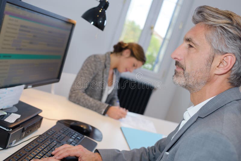Cheerful Colleagues Reviewing Proofs on Computer Stock Image - Image of ...