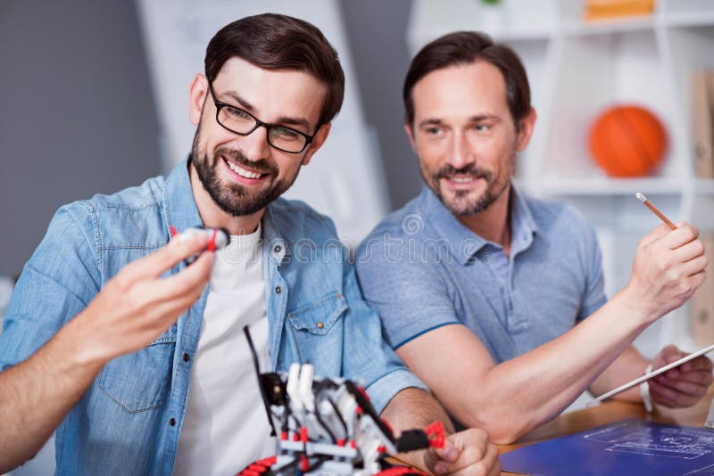 Cheerful Colleagues Working on the Robot Stock Image - Image of ...