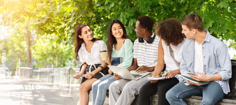 Cheerful College Students Having Discussion Outdoors while Resting ...