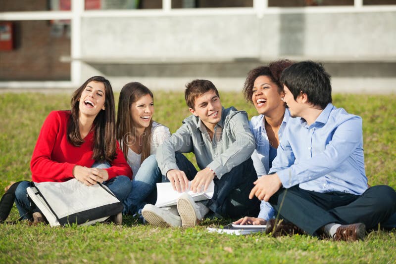 Cheerful College Students Sitting on Grass at Stock Photo - Image of ...