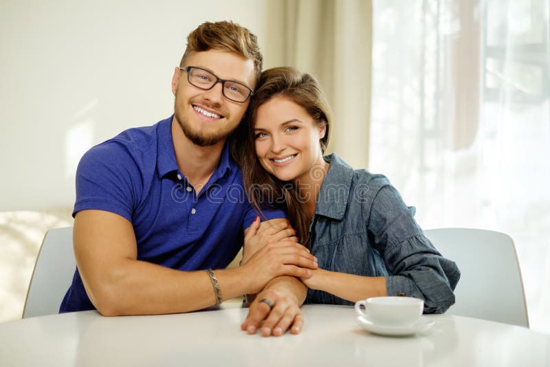 Cheerful Couple Behind Table Stock Photo - Image of apartment, house ...