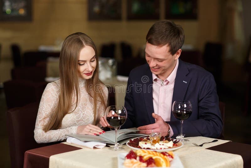 Cheerful Couple with Menu in a Restaurant. Stock Image - Image of ...