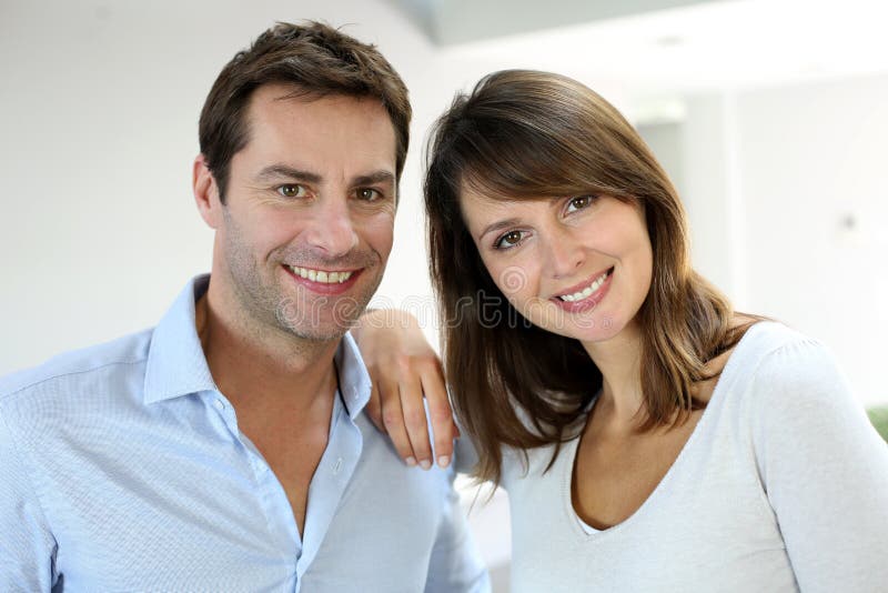 Two Couples Sitting in Living Room Smiling Stock Image - Image of ...