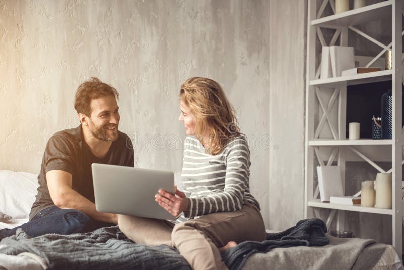 Cheerful Couple is Using Notebook at Home Stock Image - Image of ...