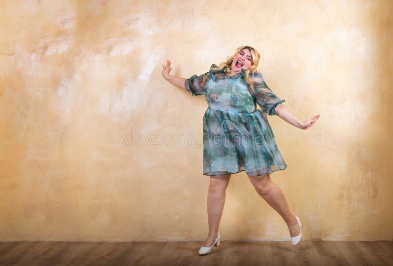 Curvy Woman Jumping and Having Fun in Studio Shooting Stock Photo ...