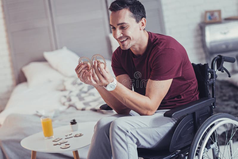 Cheerful Disabled Man Comparing the Wooden Wheels Stock Photo - Image ...
