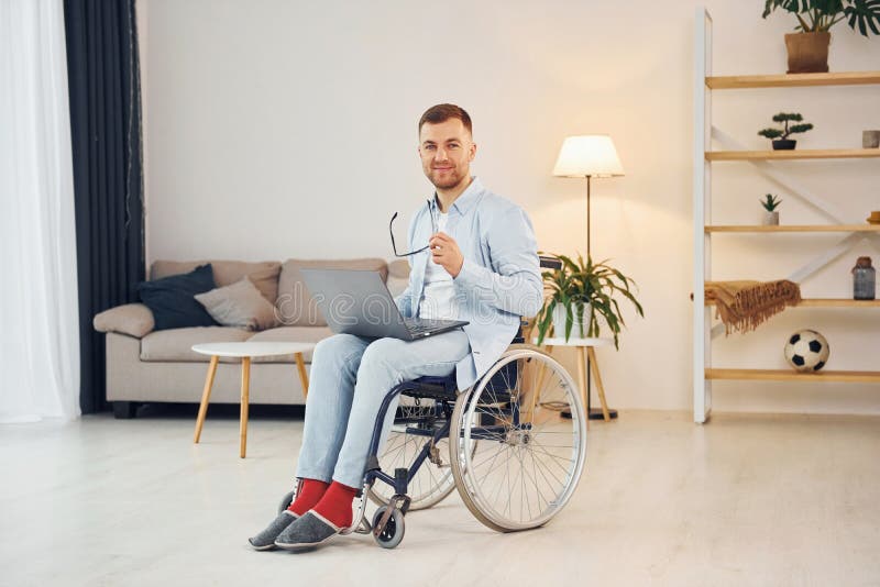 Cheerful Disabled Man in Wheelchair is at Home Stock Photo - Image of ...