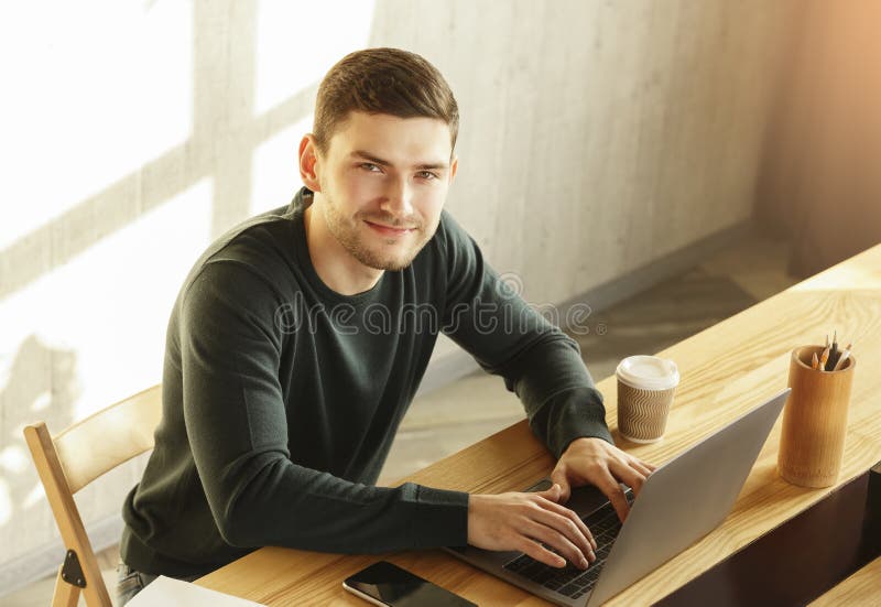 Cheerful Employee Guy Working on Laptop at Workdesk in Office Stock ...