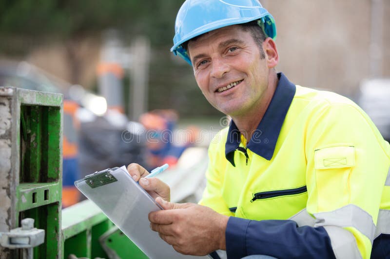 Cheerful Engineer with Clipboard Wearing Reflective Vest on ...