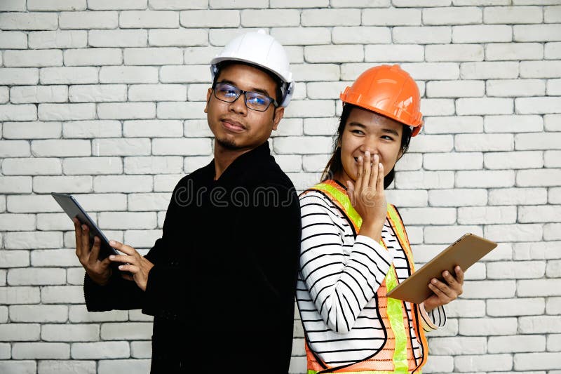 Cheerful Engineer and Contractor Holding Tablets with a Smile and ...