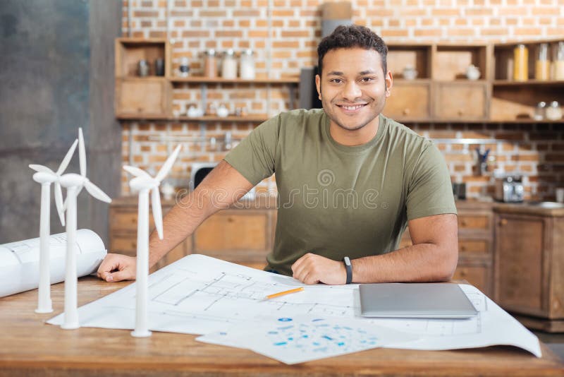 Cheerful Engineer Sitting at the Table with Drawings and Smiling Stock ...