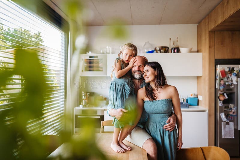Cheerful Family with One Kid Having Fun Together in Kitchen. Stock ...