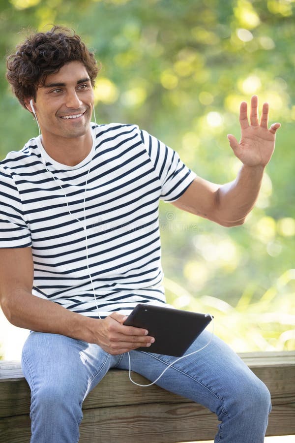 Cheerful Fashionable Handsome Man Using Tablet while Waving at Someone ...