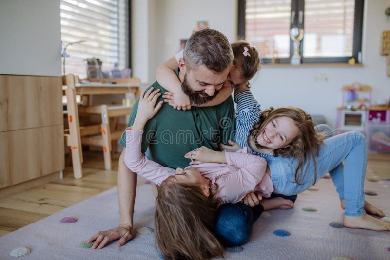 Cheerful Father with Three Little Daughters Playing Together at Home ...