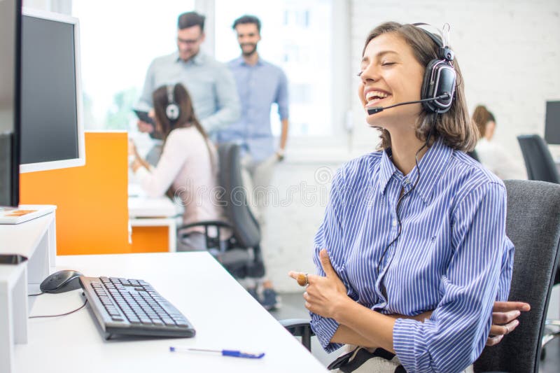 Cheerful Female Customer Support Executive Working in Office. Stock ... Cheerful Female Customer Support Executive Working in Office. Stock ...