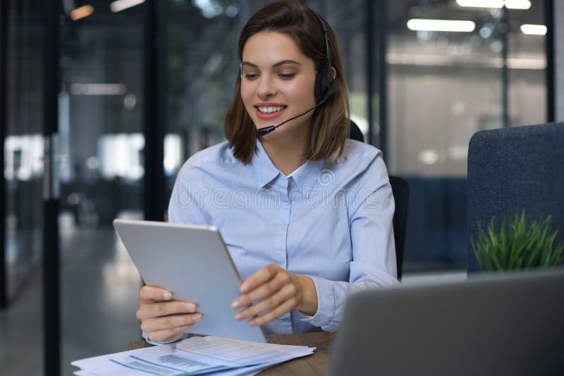Cheerful Female Manager Sitting at Office Desk and Performing Corporate ...