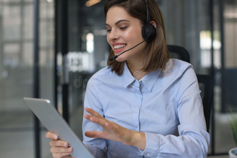Cheerful Female Manager Sitting at Office Desk and Performing Corporate ...