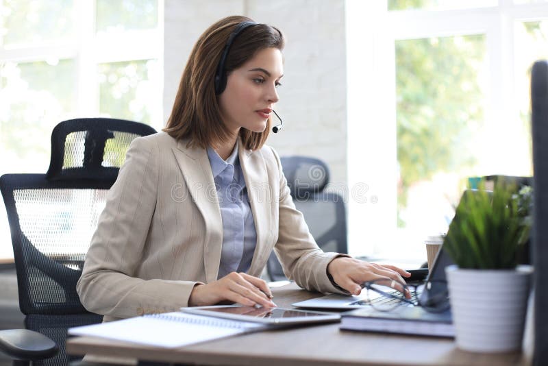 Cheerful Female Manager Sitting at Office Desk and Performing Corporate ...