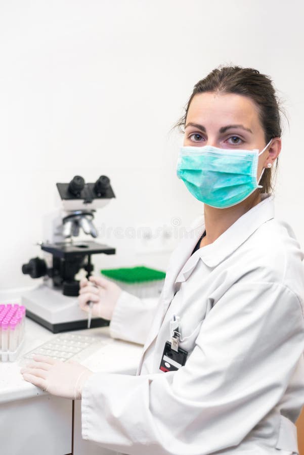 Cheerful Female Scientist with Protective Mask Posing at the Laboratory ...