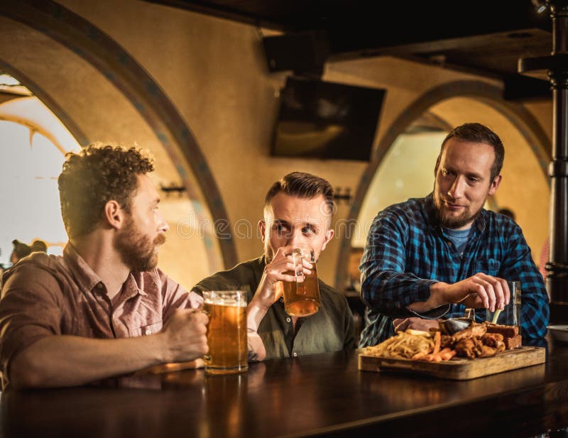 Cheerful Friends Drinking Draft Beer in a Pub Stock Photo - Image of ...