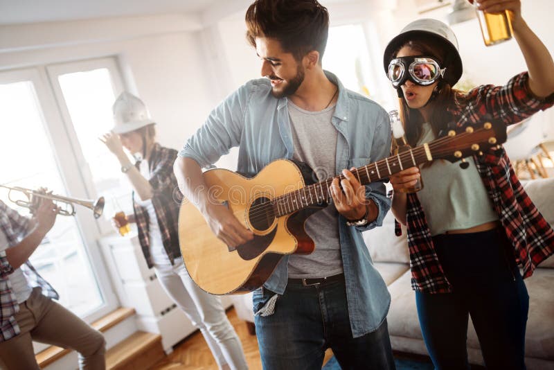 Cheerful Friends Having Party Together and Playing Instruments Stock ...