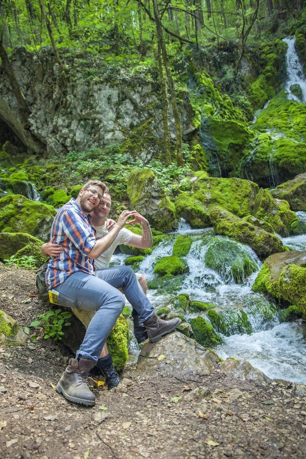 Cheerful Friends Posing in Nature by a Waterfall Stock Photo - Image of ...