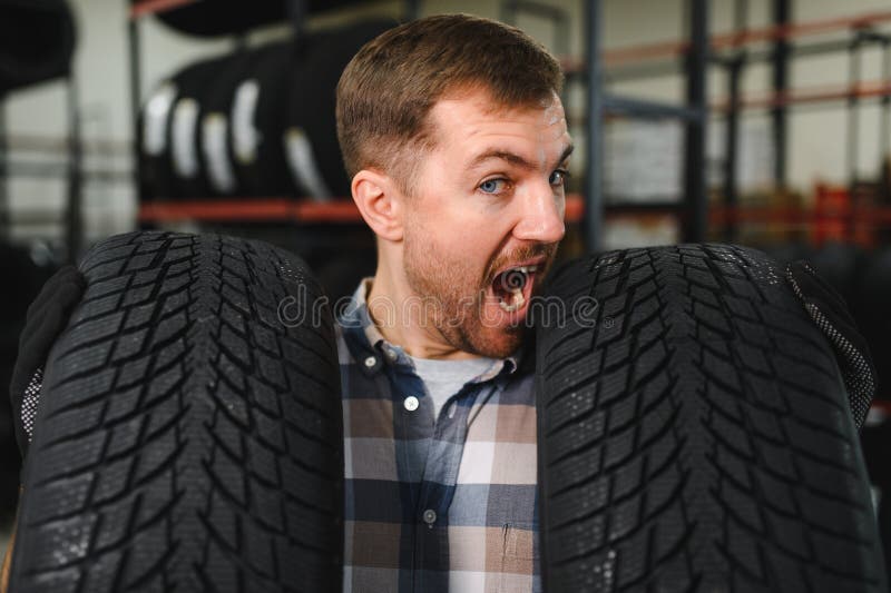 Cheerful and Funny Tire Shop Worker. Car Tire Shop Stock Photo - Image ...