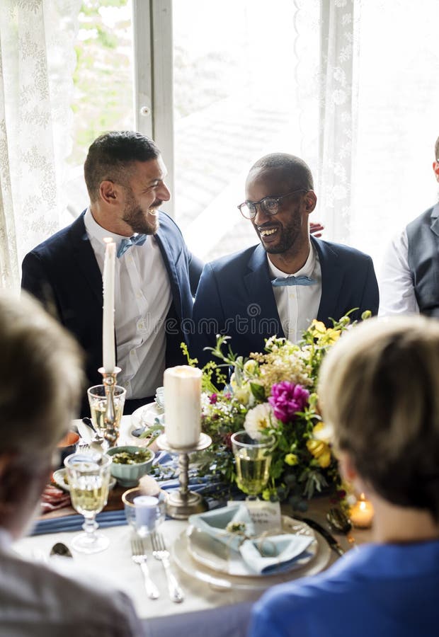 Gay Couple Cutting Cake Together on Wedding Reception Stock Photo ...