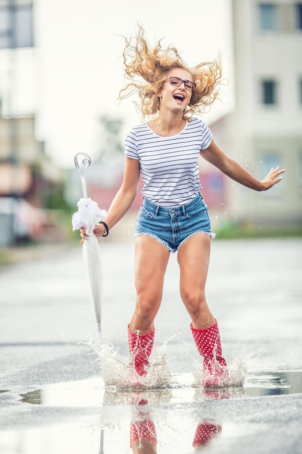 Cheerful Girl Jumping With White Umbrella In Dotted Red Galoshes Hot