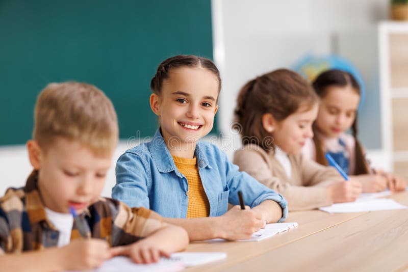 Cheerful Girl Solving Test with Classmates at School Stock Image ...