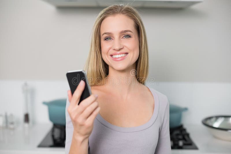 Cheerful Gorgeous Model Holding Smartphone Looking at Camera Stock ...