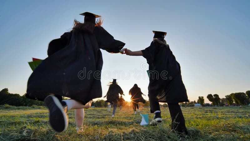 Cheerful Graduates Students Run after School at Sunset. Stock Photo ...